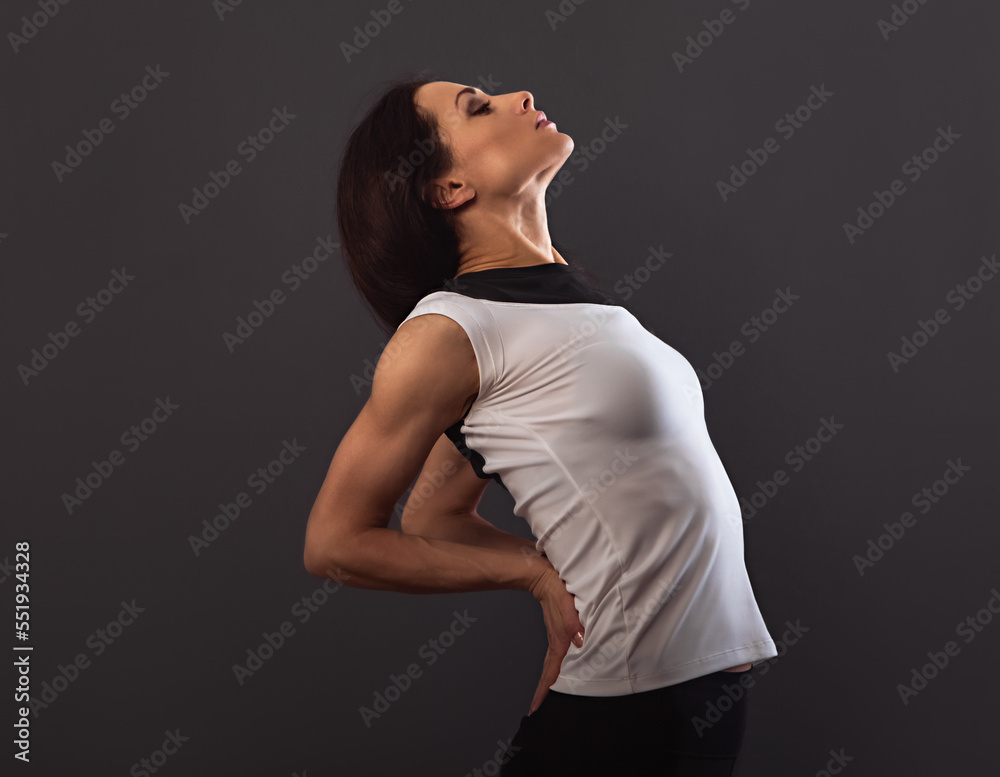 Strong sporty woman doing the arms and shoulders stretching arch ...