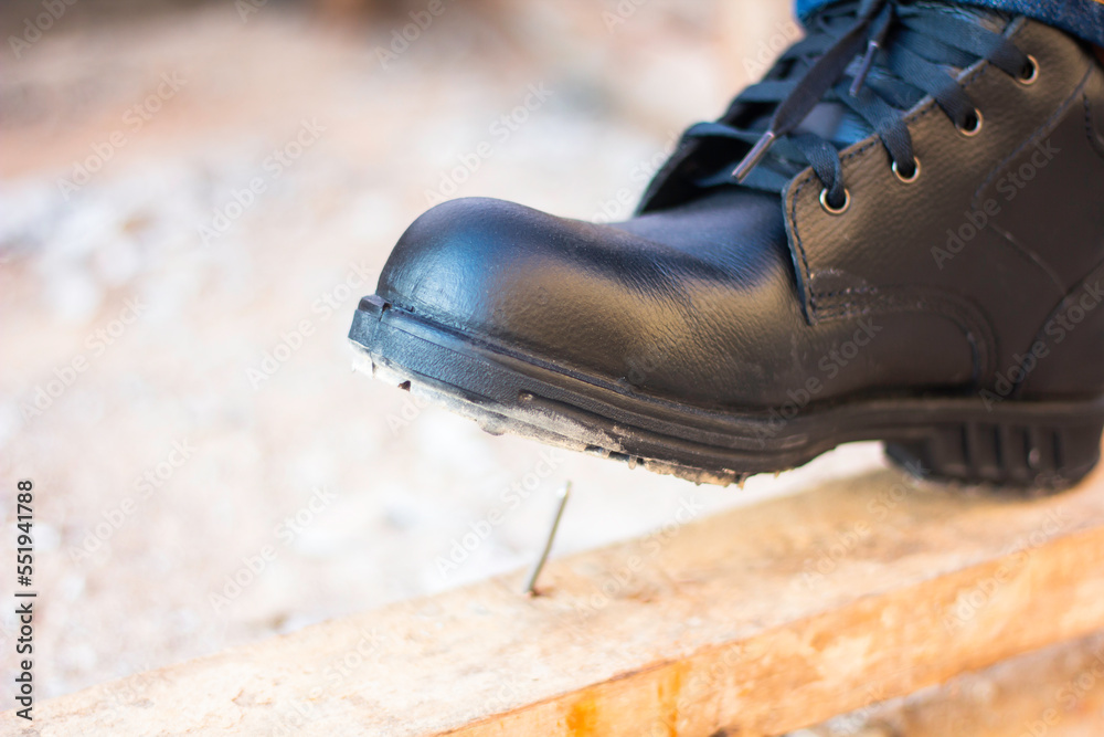 Wear safety shoes to ensure safety at work. construction workers wear ...