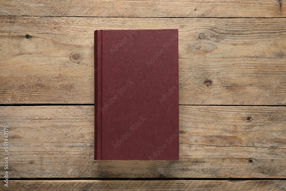 Closed hardcover book on wooden table, top view Stock Photo | Adobe Stock