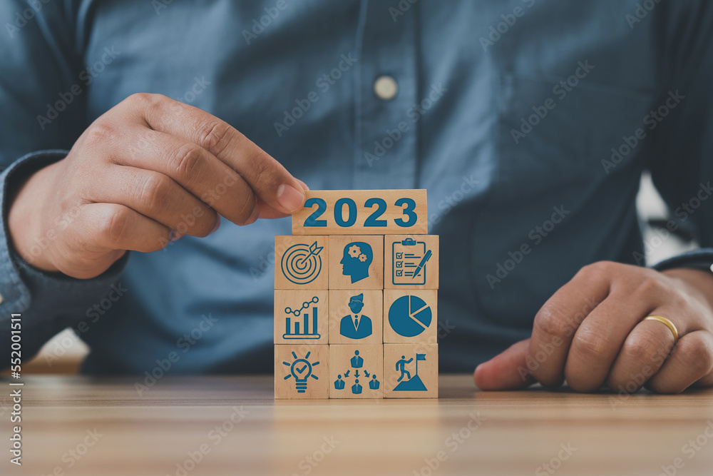 Business management and financial concept. 2023 goal and target. Hand pick dartboards with 2023 ...