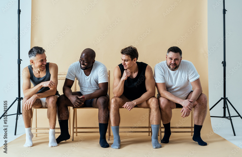group of multiethnic men posing for a male edition body positive beauty ...