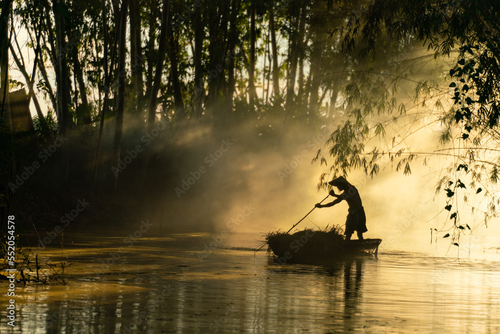Photo of a local asian old man male boatman wearing conical hat rowing ...