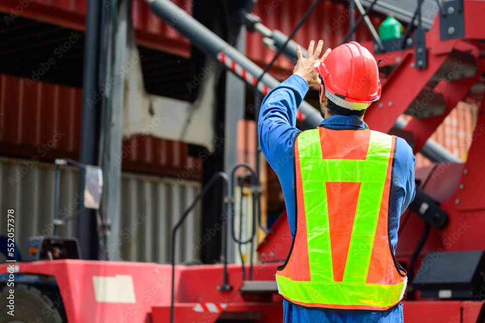 Back view of male engineer foreman checking and controlling loading ...
