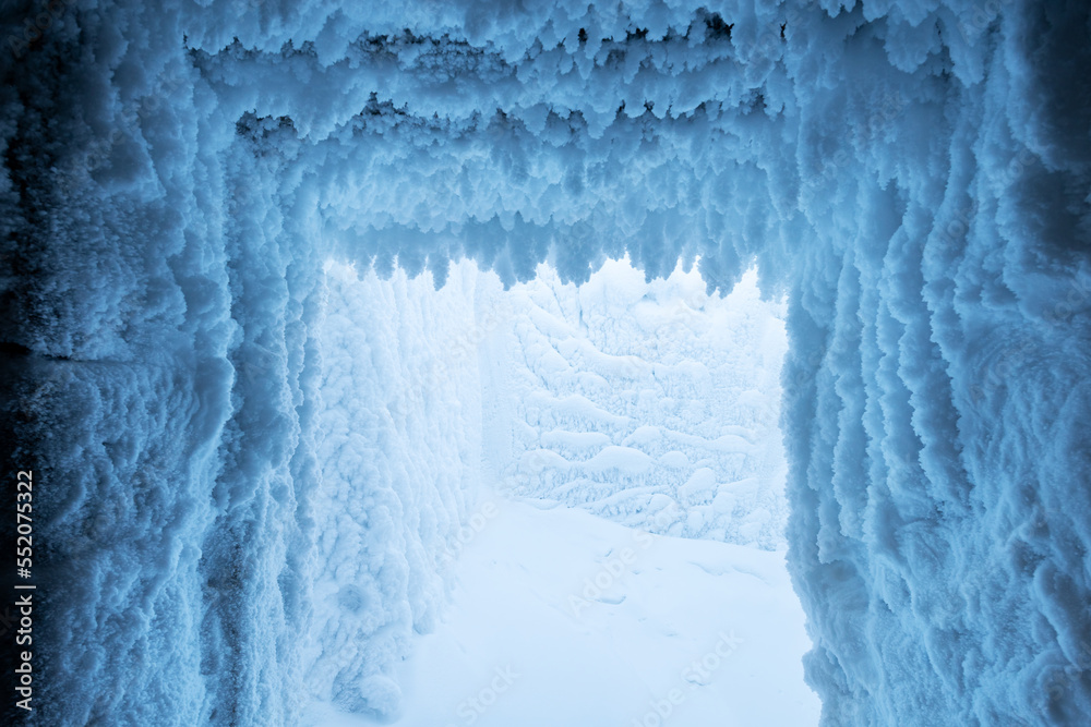 Winter Christmas background of frozen snow growths on the ceiling and ...