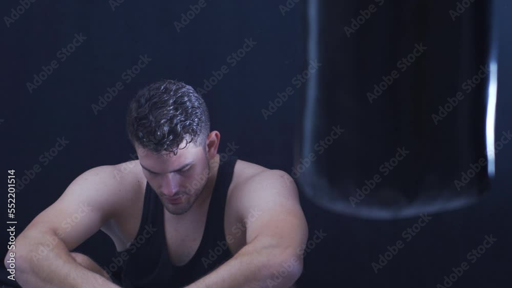 Determined and focused male boxer boxing in dark field. Male boxer ...