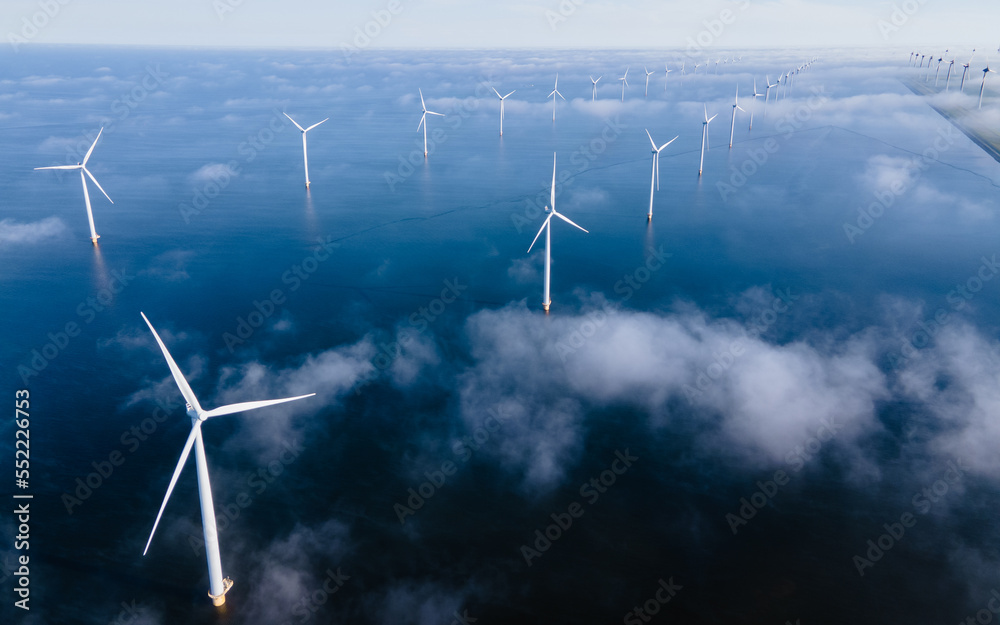Aerial view at Windmill park with windmills turbines and a cloudy sky ...