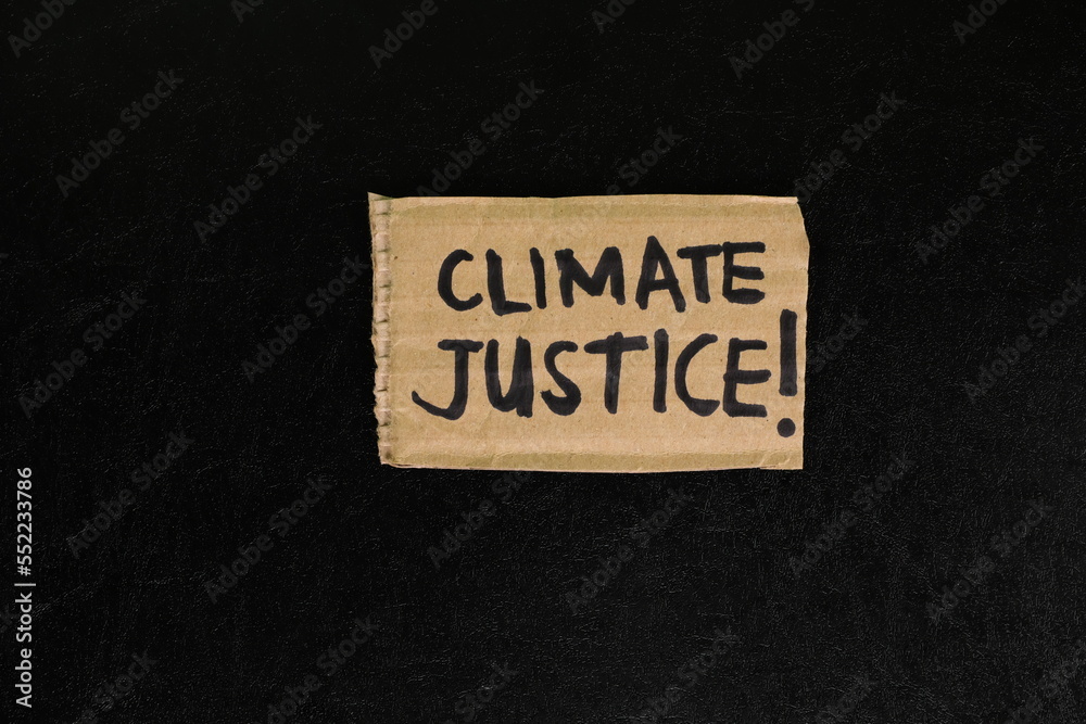Climate justice concept. Carton placard with handwritten message in ...