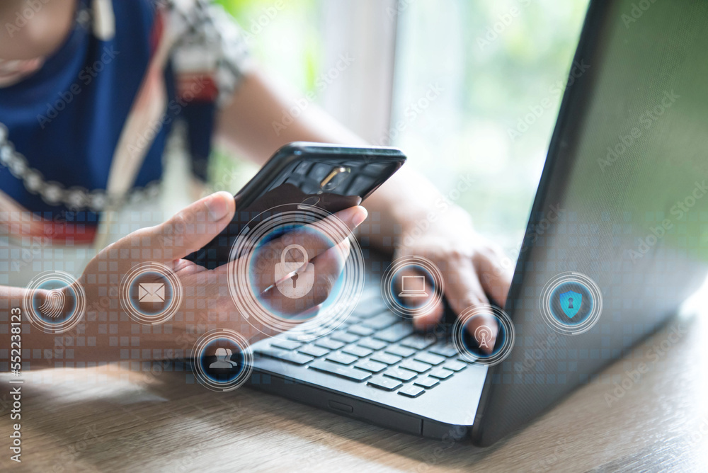 woman's using smartphone and computer notebook for information security ...