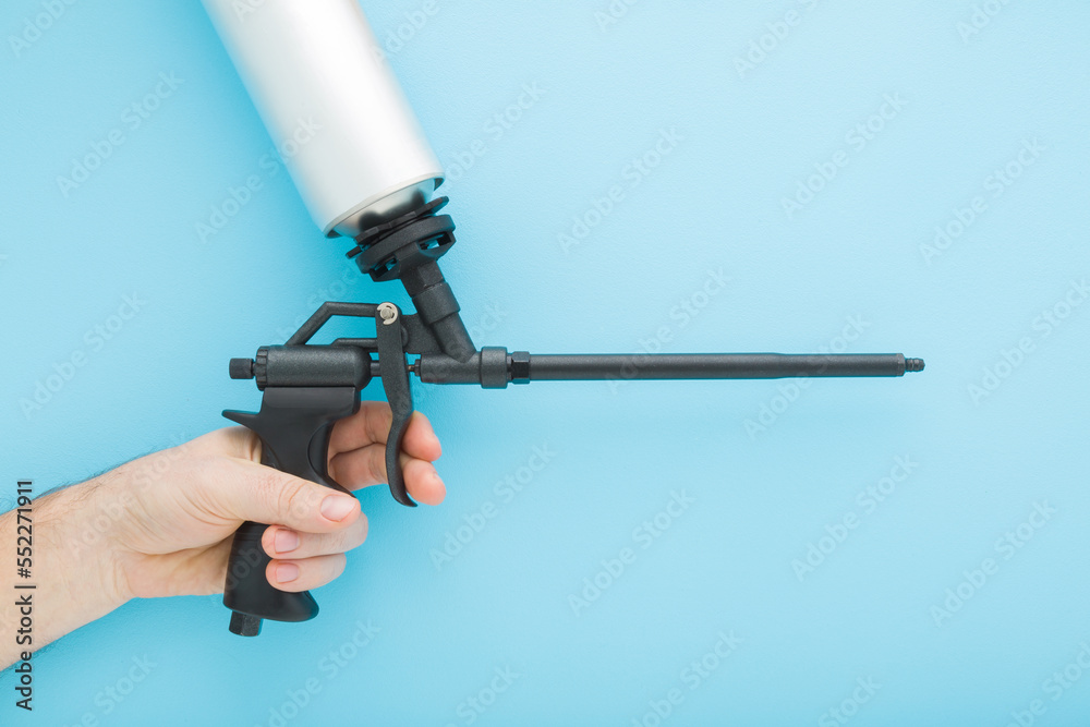 Young adult man hand holding and showing black professional foam spray ...