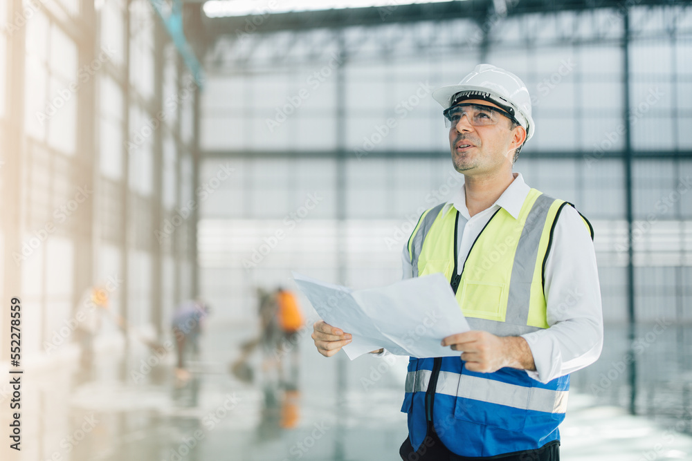 warehouse manager with tablet and ..radio communication his worker ...