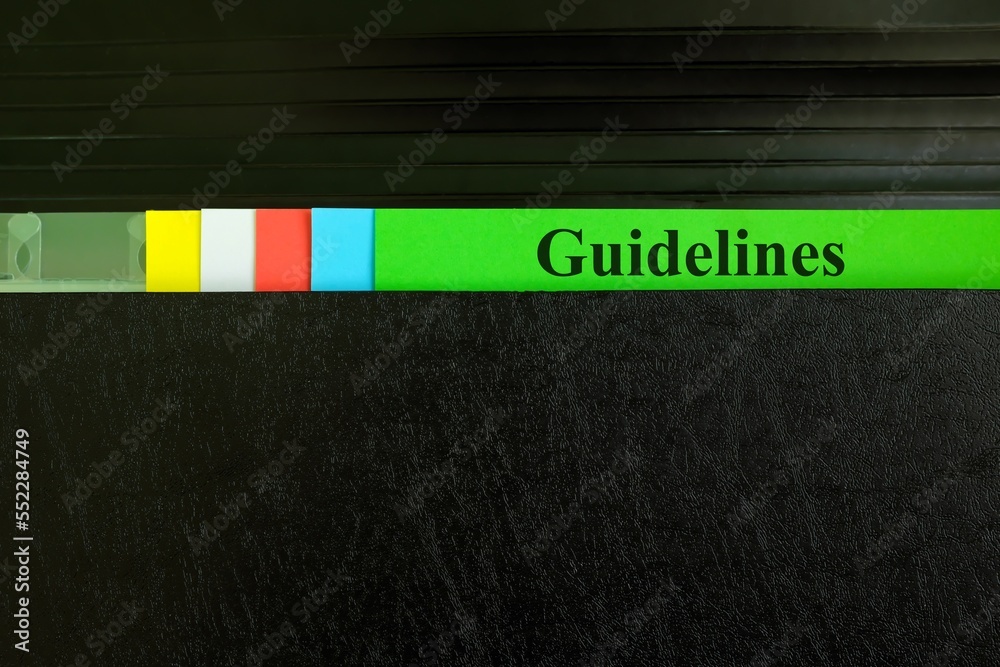 Hand picking guidelines file record in black binder folder. Work ...