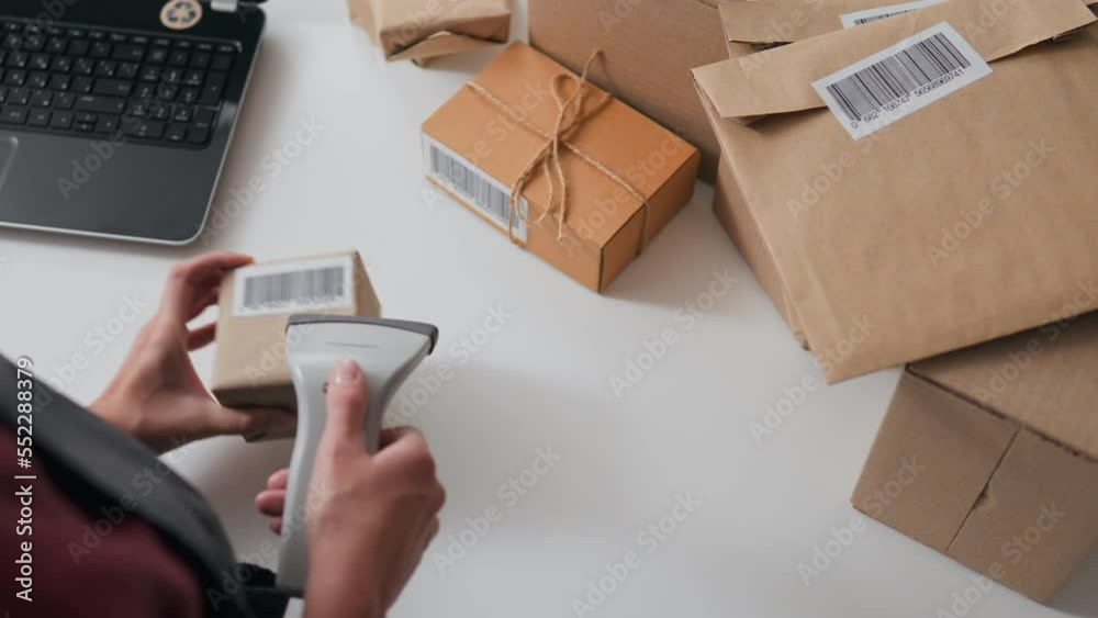 Worker manager scans the goods top view, the scanner scans the barcode ...