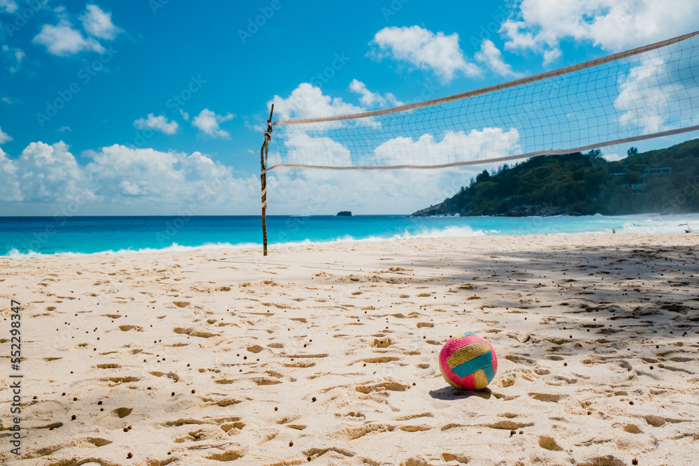 Volleyball net on tropical beach with blue sky. Beach volleyball court ...