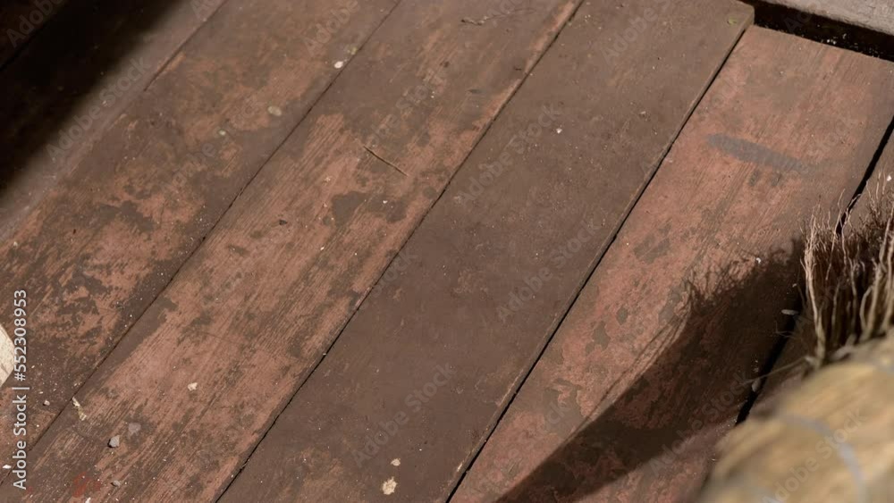 Person Sweeping an Old Dirty Wooden Floor with Broom in the Garage in ...
