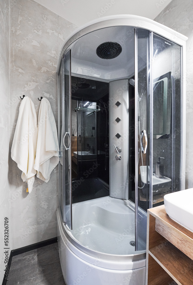 Small gray tile bathroom with fully equipped shower cabin and ceramic ...