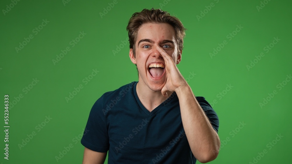 Portrait of happy young man 20s smiling scream and shout calling waving ...