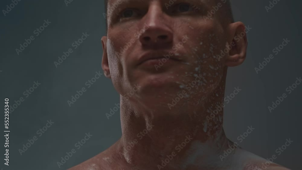 Athletic male model smears face and body with white cream Stock Video ...