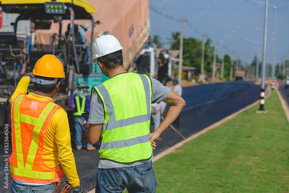 Asian architectural engineer working at road construction site For ...