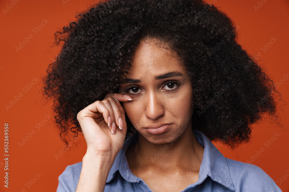 Sad crying african american woman wiping tears and looking at camera ...
