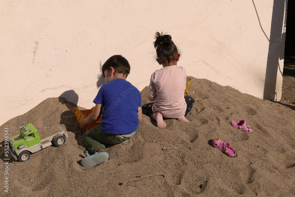 children playing in the sand, happy children playing in the sand in the ...