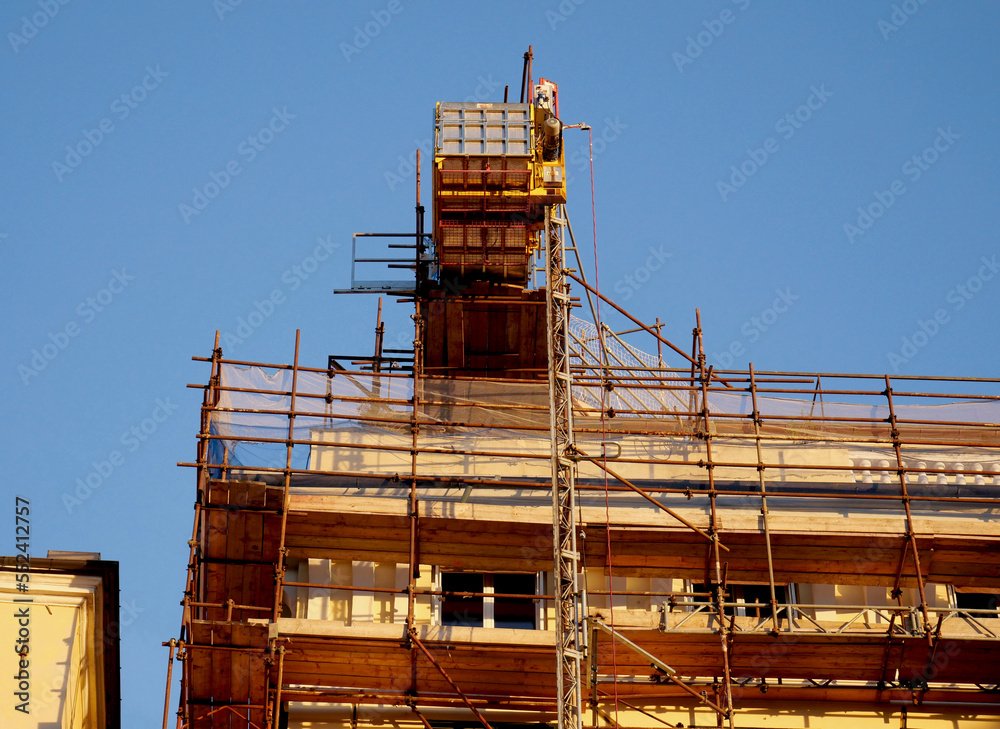 Scaffolding with freight elevators on a building under renovation Stock ...