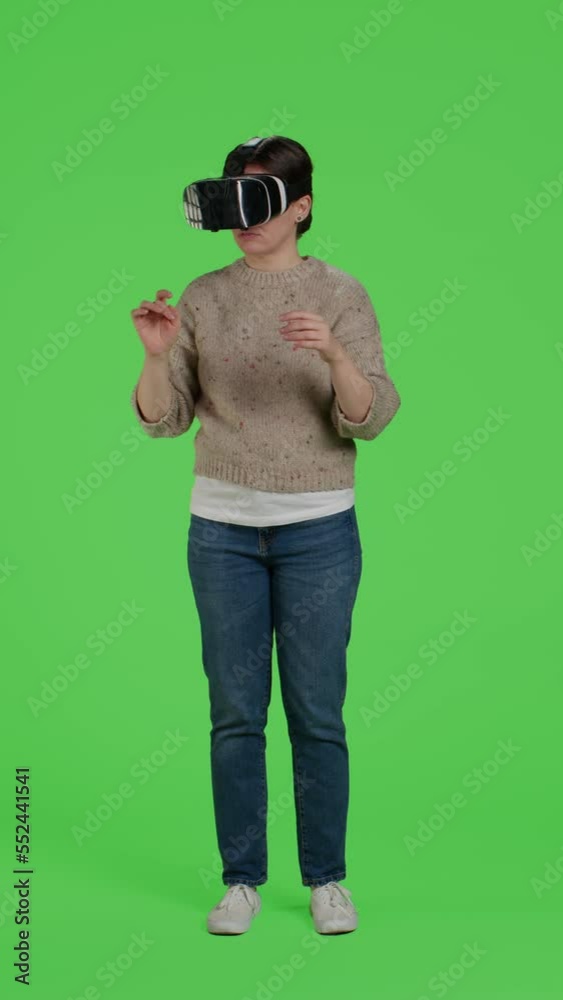 Vertical video: Front view of young adult using vr glasses over full ...