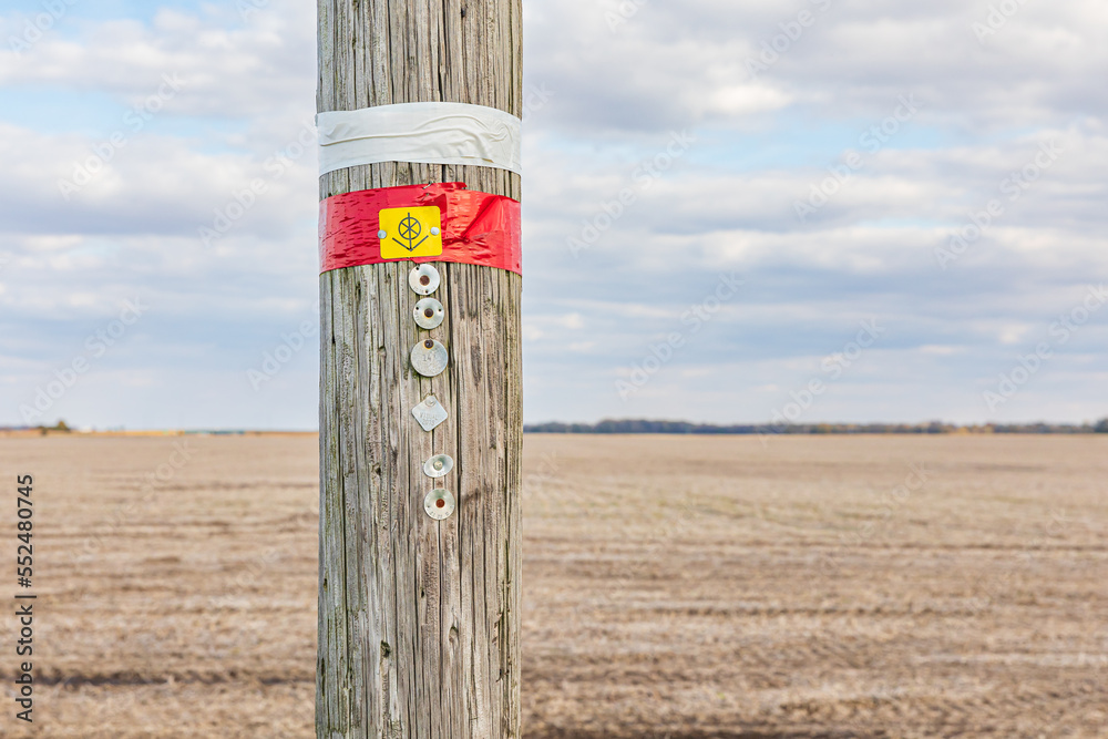Inspection tag on electric utility power pole. Electrical grid safety ...