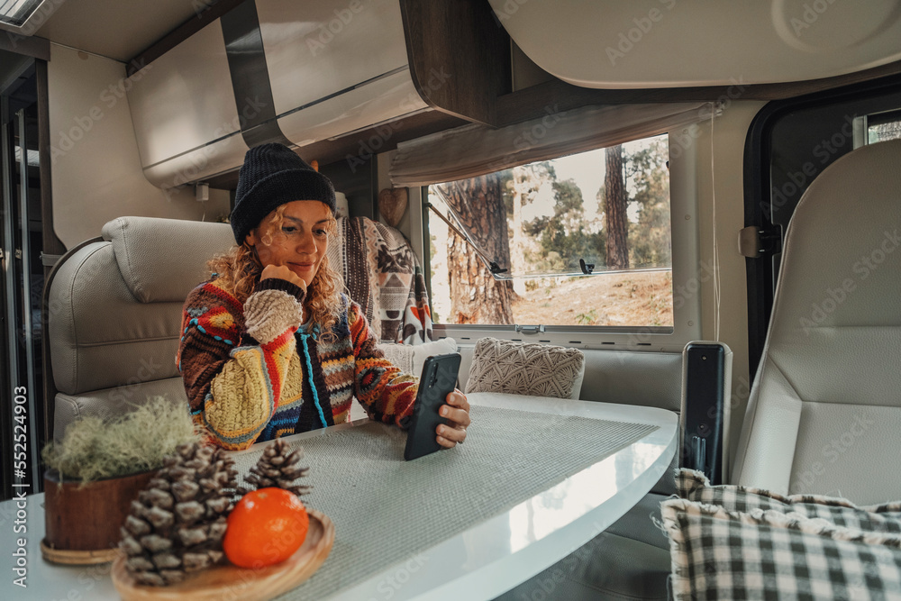 One woman living inside a modern camper van motorhome sitting at the ...