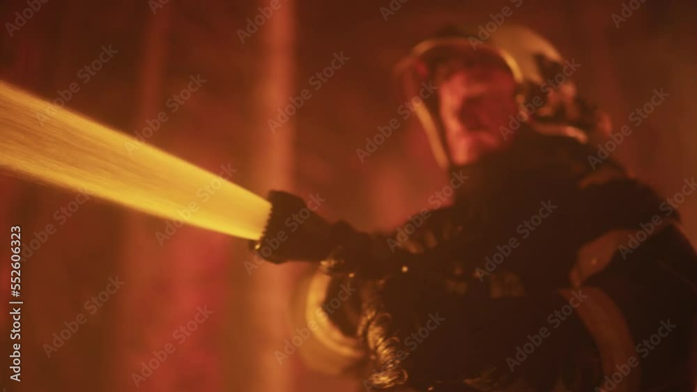 Close Up Low Angle Portrait of a Brave Professional Firefighter Using a ...