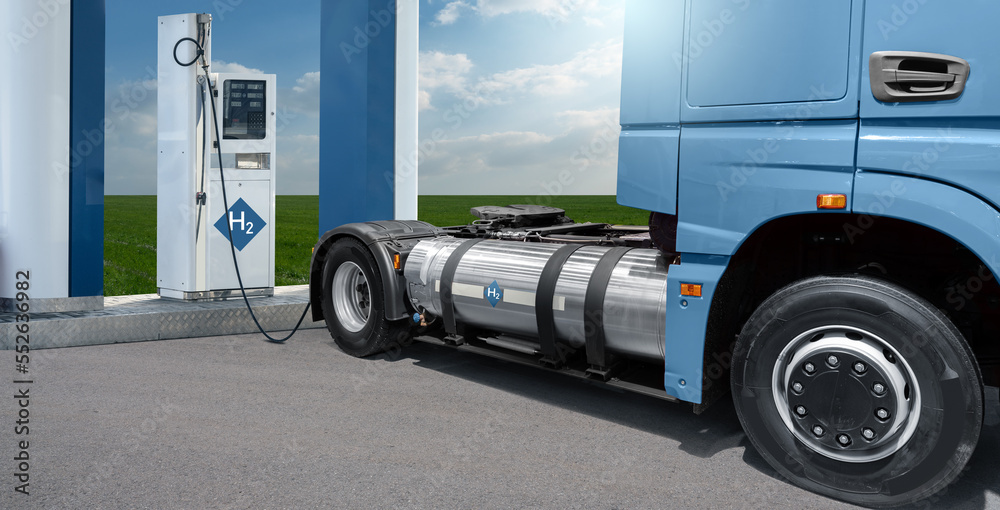 A hydrogen fuel cell semi truck with H2 gas cylinder onboard next to ...