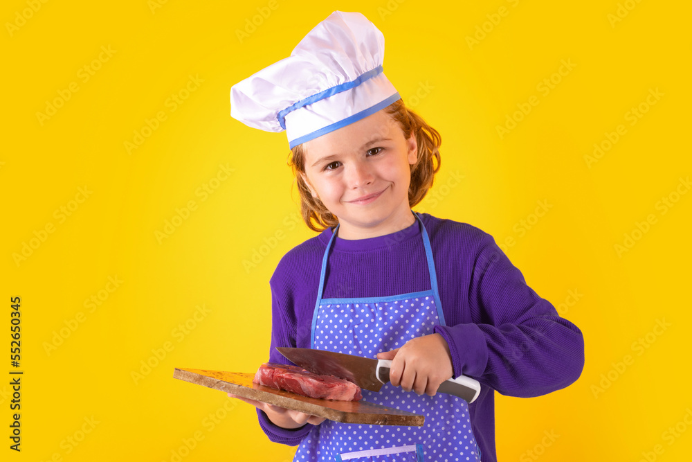 Kid cook hold cutting board with meat beef steak and knife. Child chef ...