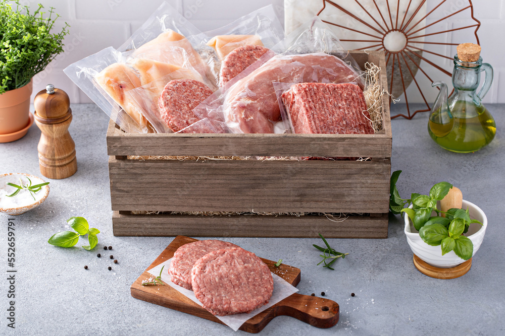 Meat delivery box, variety of meat chops and packages in a wooden crate ...