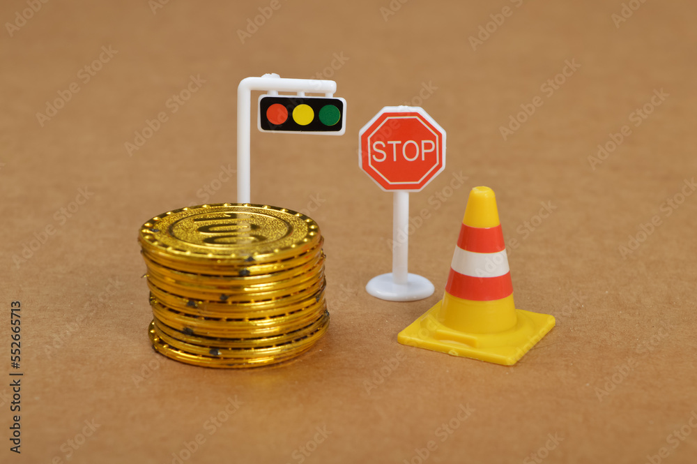 Coins, traffic light toy, stop sign and plastic cone. Violation of ...