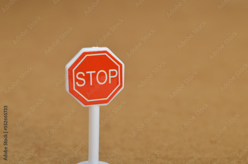 Stop sign symbol isolated on a brown background. Stock Photo | Adobe Stock