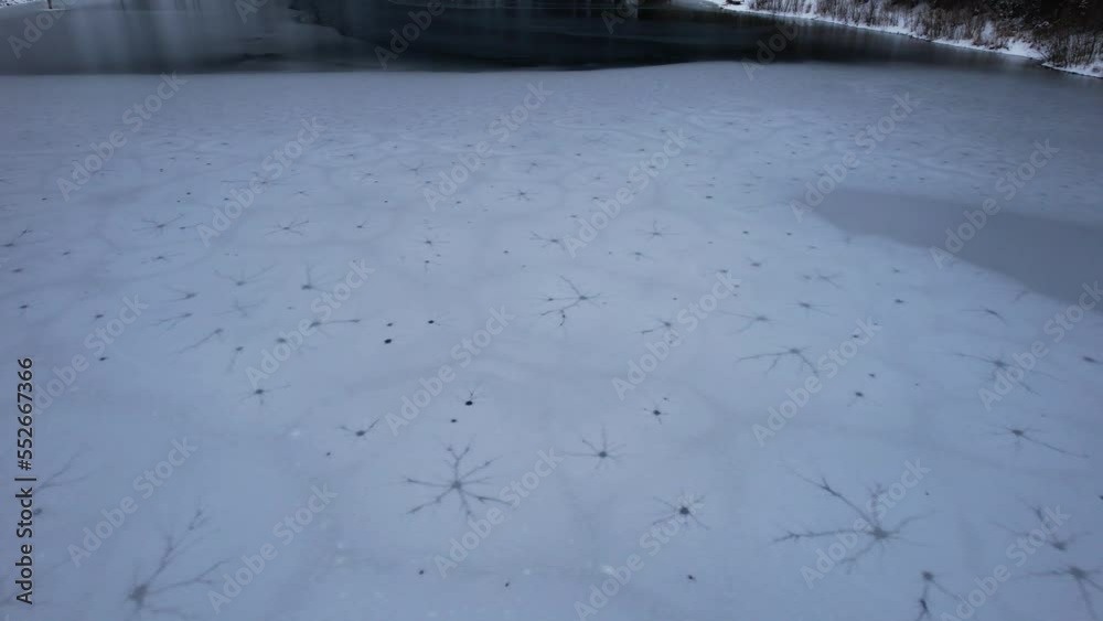 Unusual ice patterns on the mountain lake of Kaindy. Aerial view from a ...