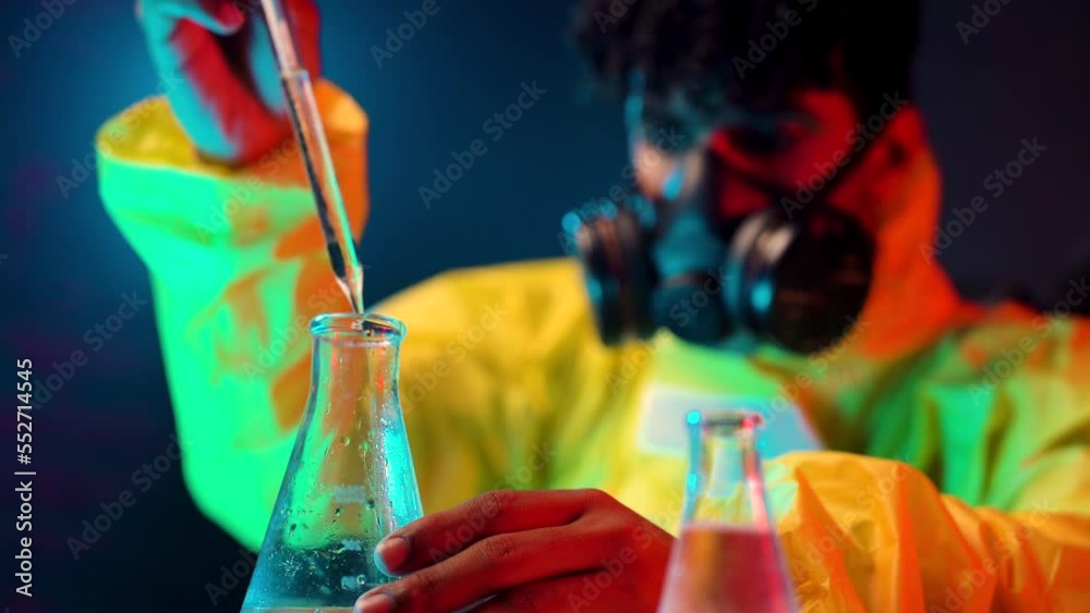 scientist dropping chemical transparent liquid with chemical pipette in ...