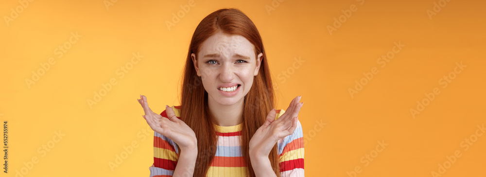 Awkward unhappy worried young redhead girl cringe feel sorry ...