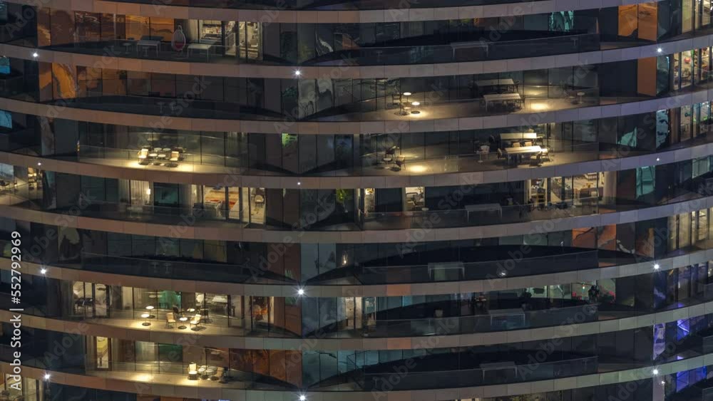 Outside view of windows in apartments of a high class building at night ...