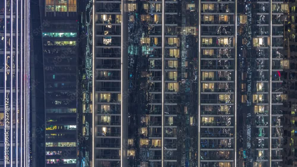 Windows lights in modern tower buildings timelapse at night. Multi ...