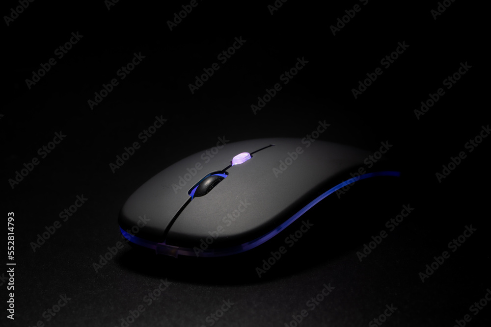 glowing wireless computer mouse in the dark Stock Photo | Adobe Stock