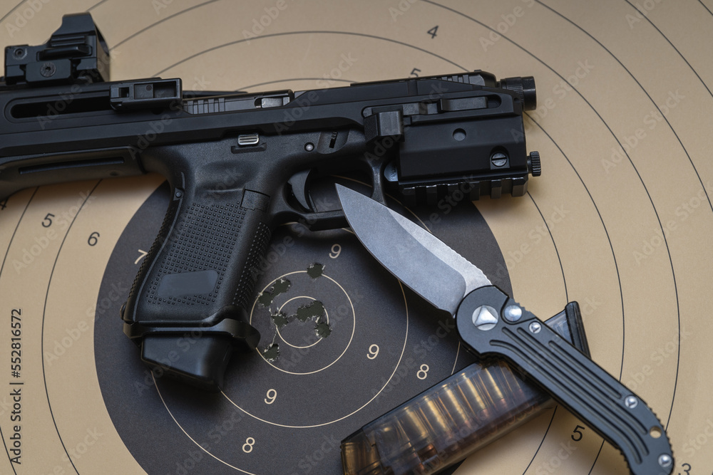 Tactical equipment, a folding knife, a modern pistol with a red dot ...