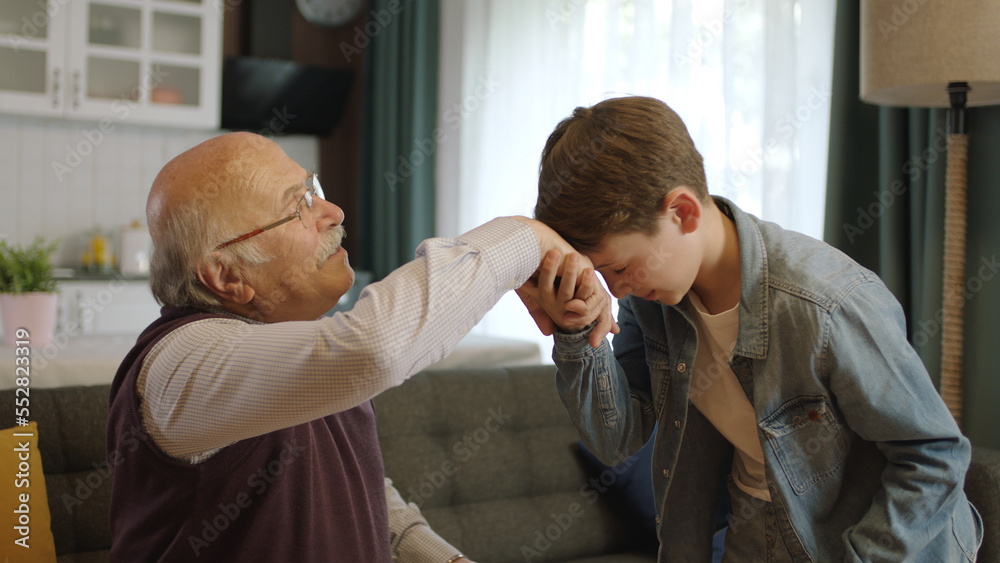 Foto de A child kissing his grandfather's hands during the feast ...