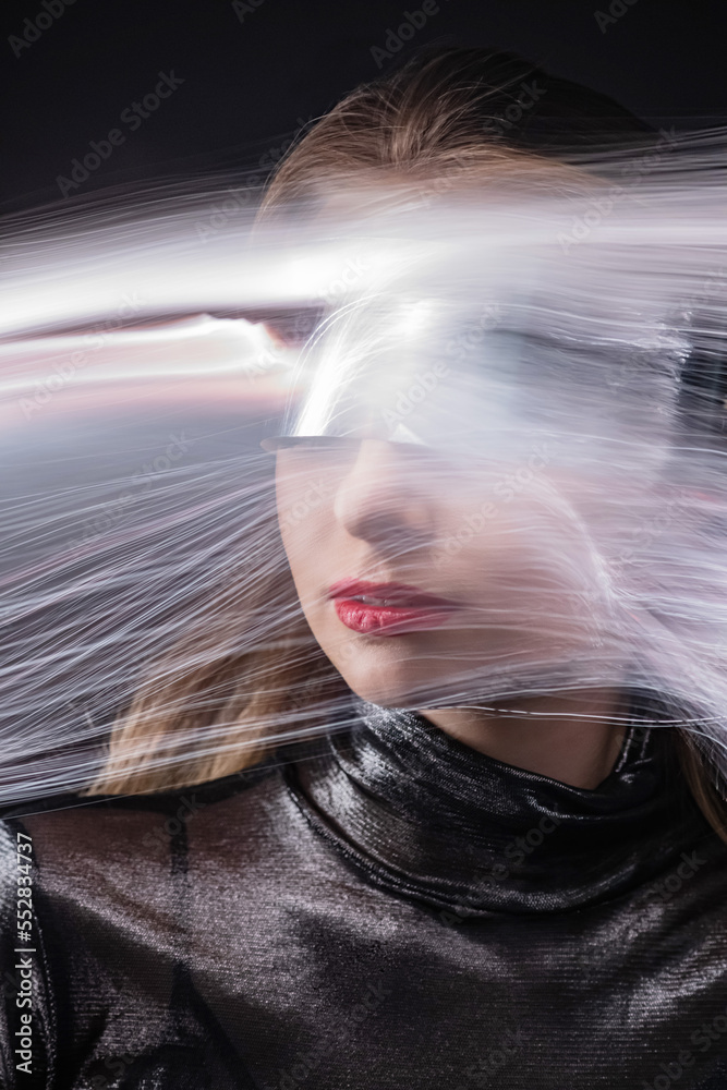 Abstract woman face silhouette in bright light trails of light painting ...