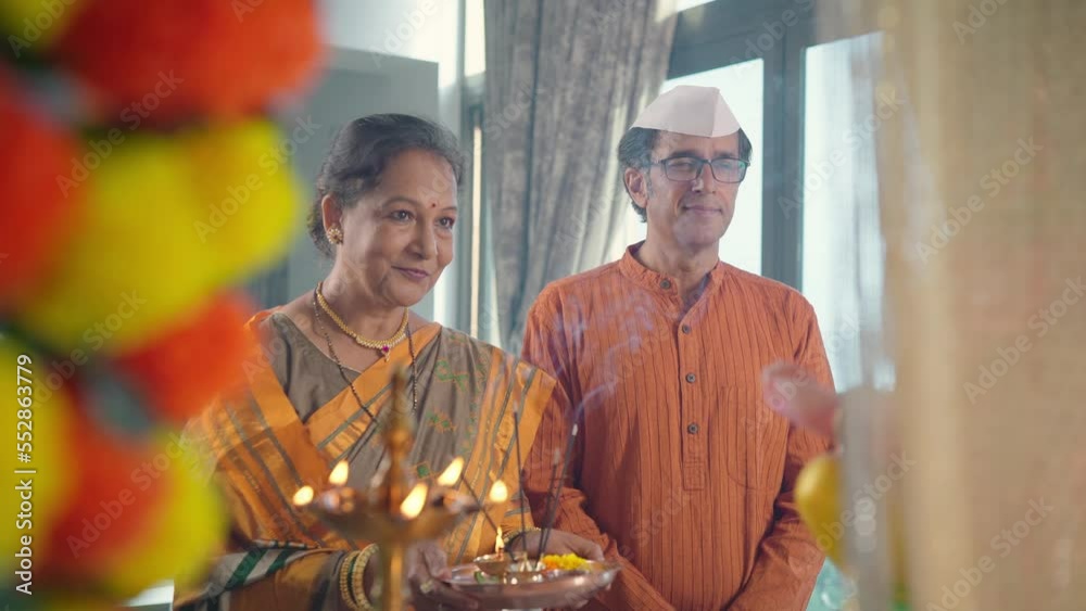 Happy ethnic Hindu Indian old or elderly married couple praying or ...