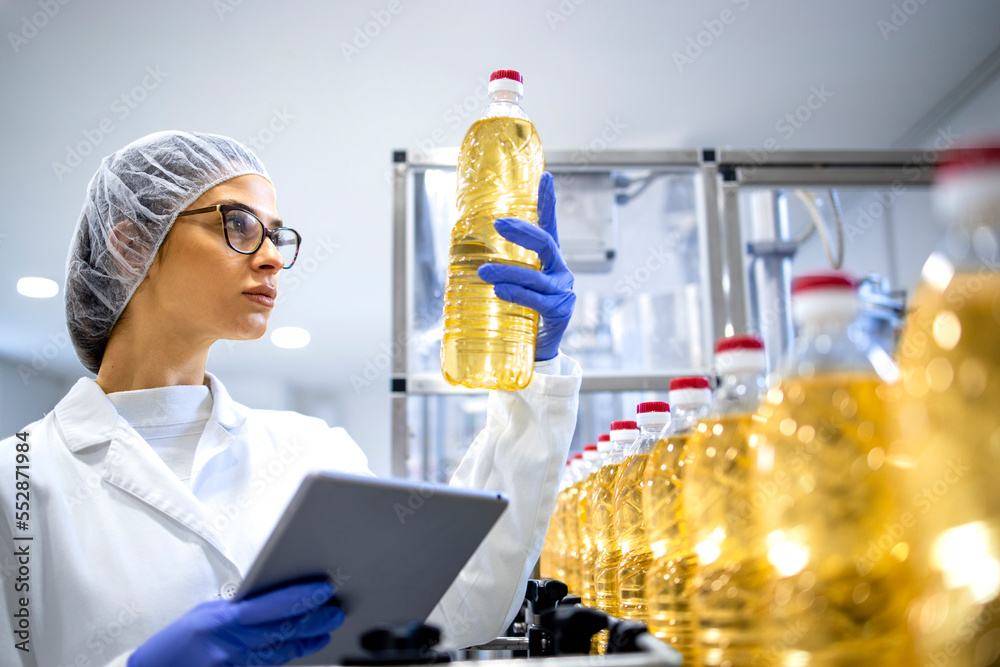 Food inspector doing visual inspection of the product inside production ...