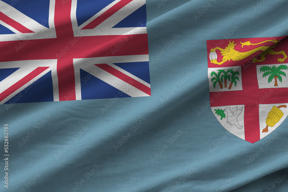 Fiji flag with big folds waving close up under the studio light indoors ...