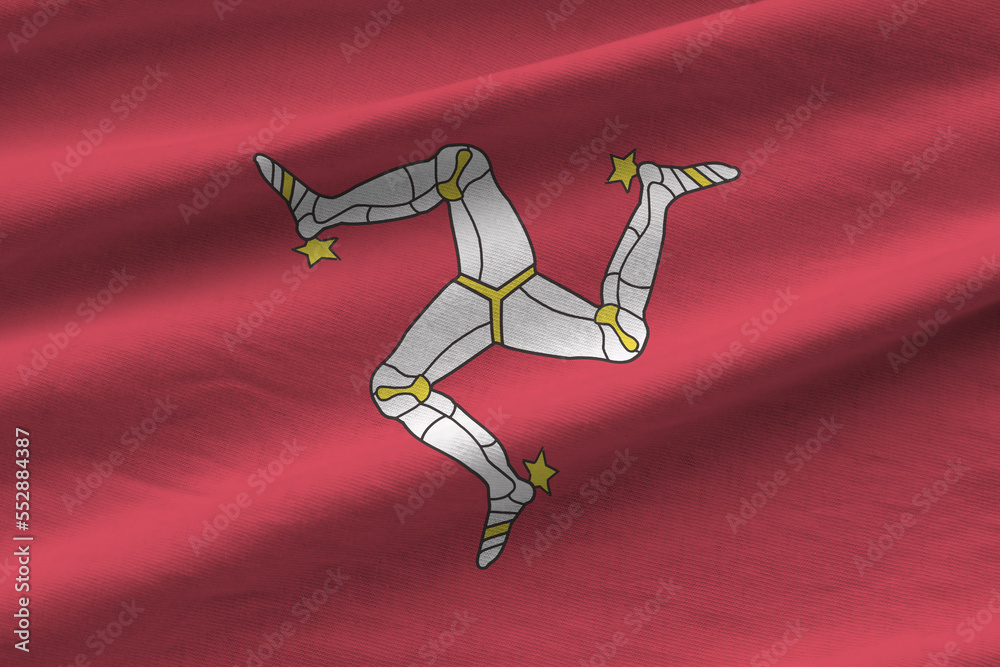 Isle of Man flag with big folds waving close up under the studio light ...