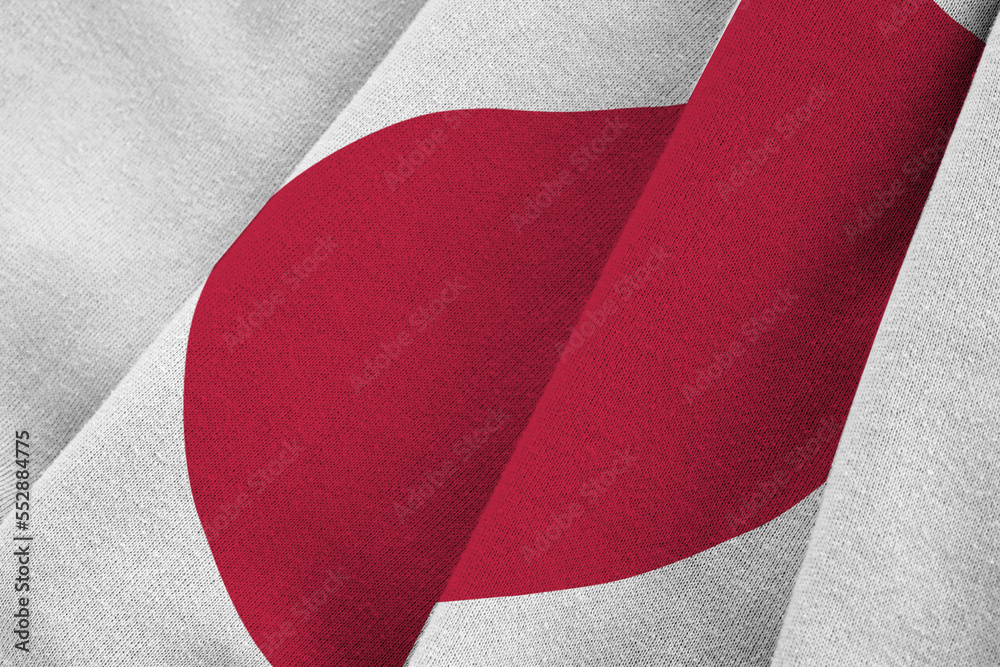 Japan flag with big folds waving close up under the studio light ...