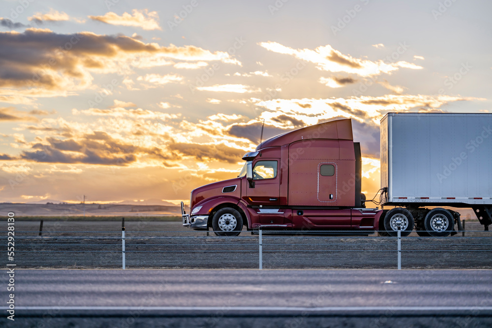 Burgundy big rig semi truck with grille guard and high cab spoiler ...