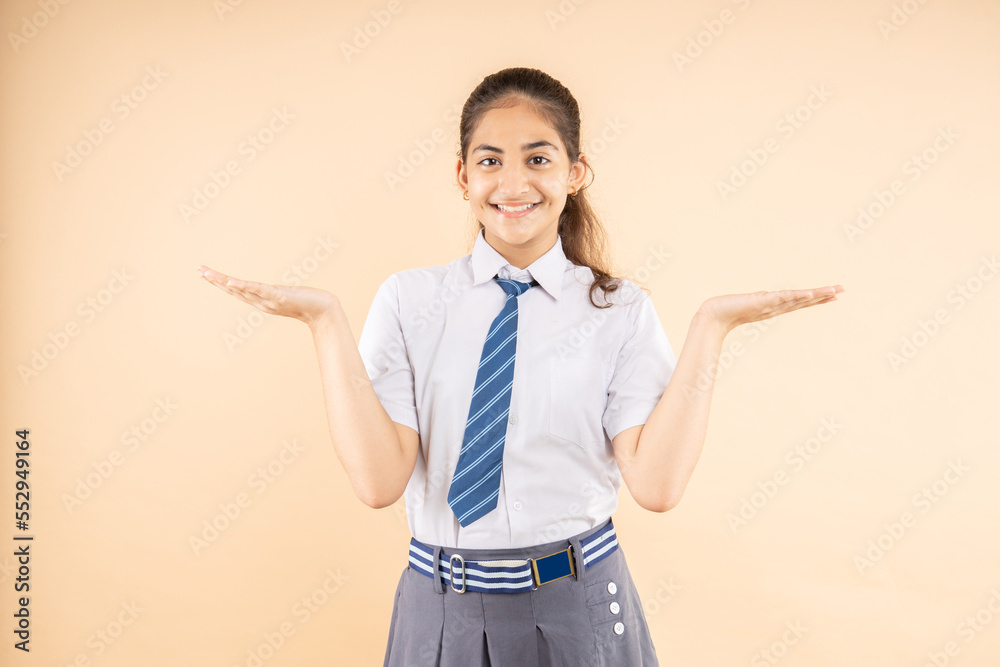 Happy Indian student schoolgirl wearing school uniform standing with ...